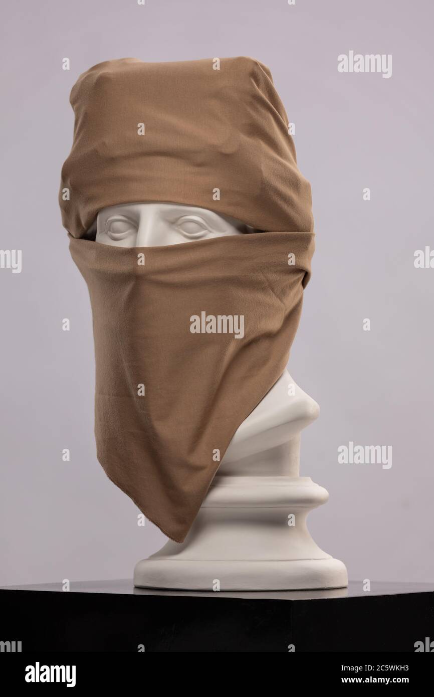 White plaster statue of a bust of Apollo Belvedere in hijab niqab Stock ...