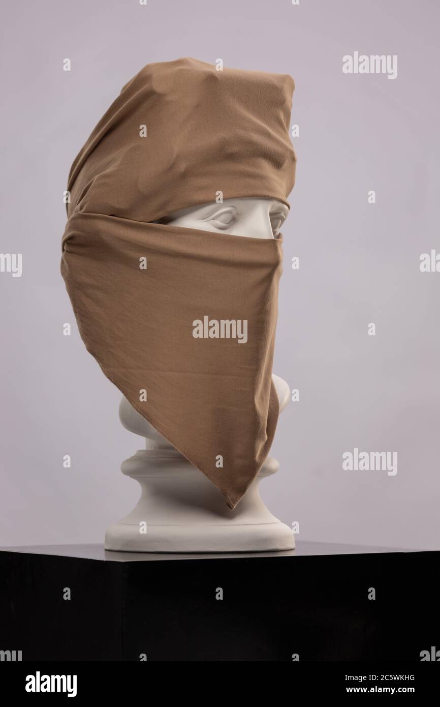 White plaster statue of a bust of Apollo Belvedere in hijab niqab Stock ...