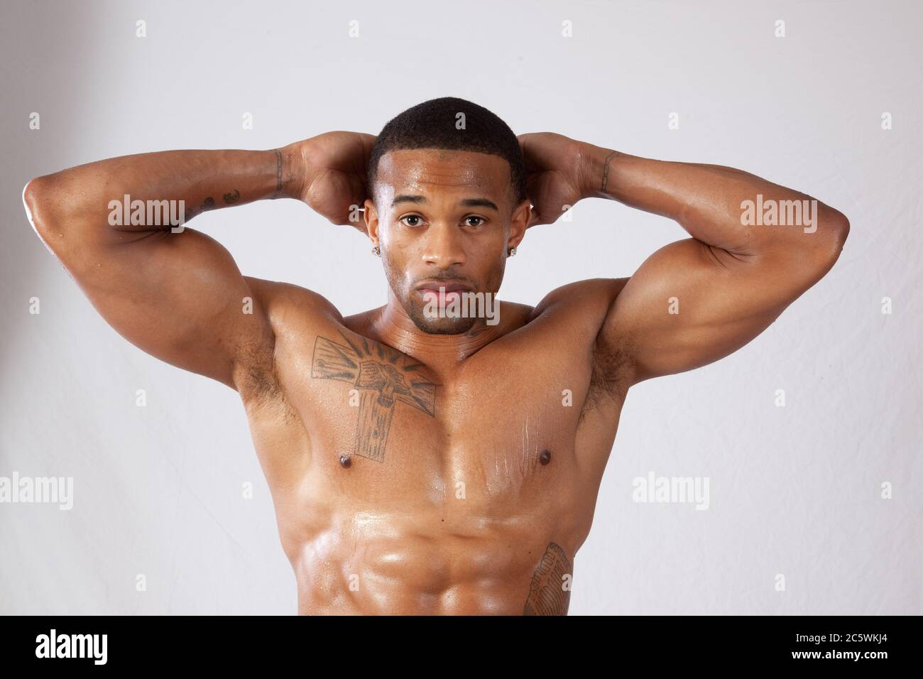 Strong Black man flexing his muscles Stock Photo - Alamy