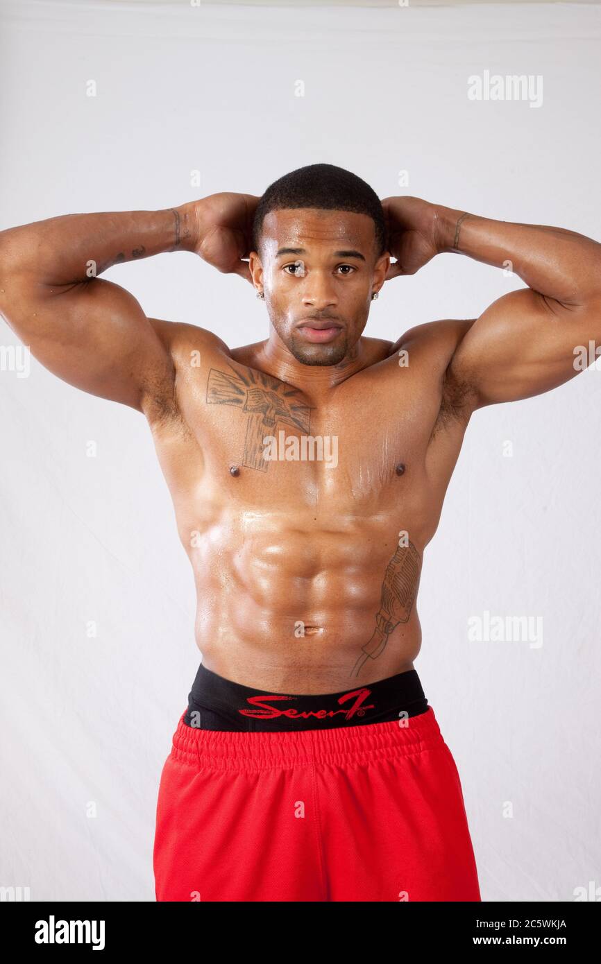 Strong Black man flexing his muscles Stock Photo - Alamy