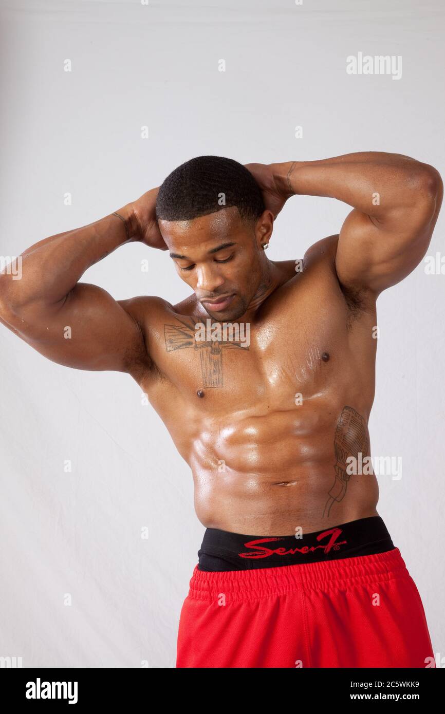 Strong Black man flexing his muscles Stock Photo - Alamy