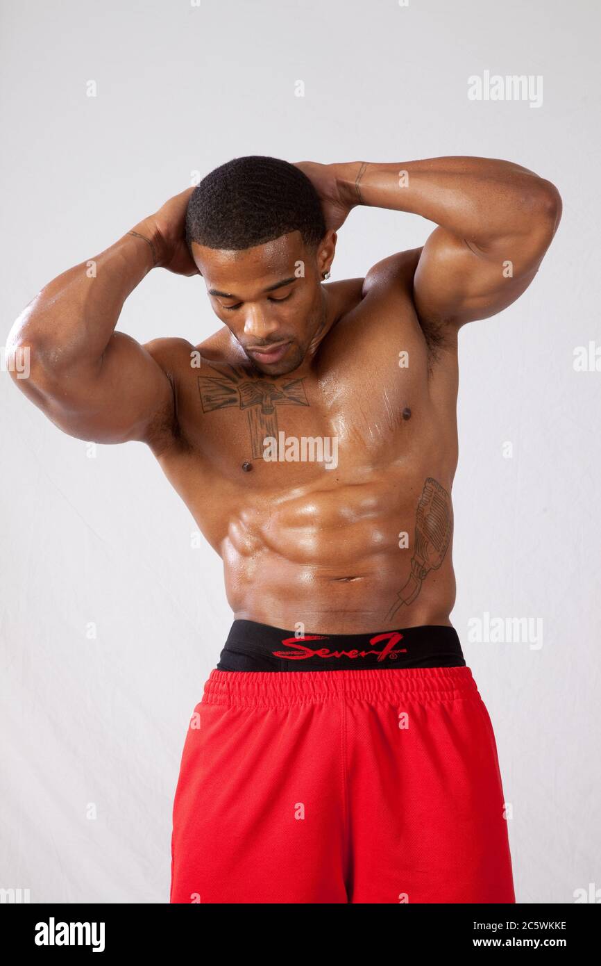 Strong Black man flexing his muscles Stock Photo - Alamy