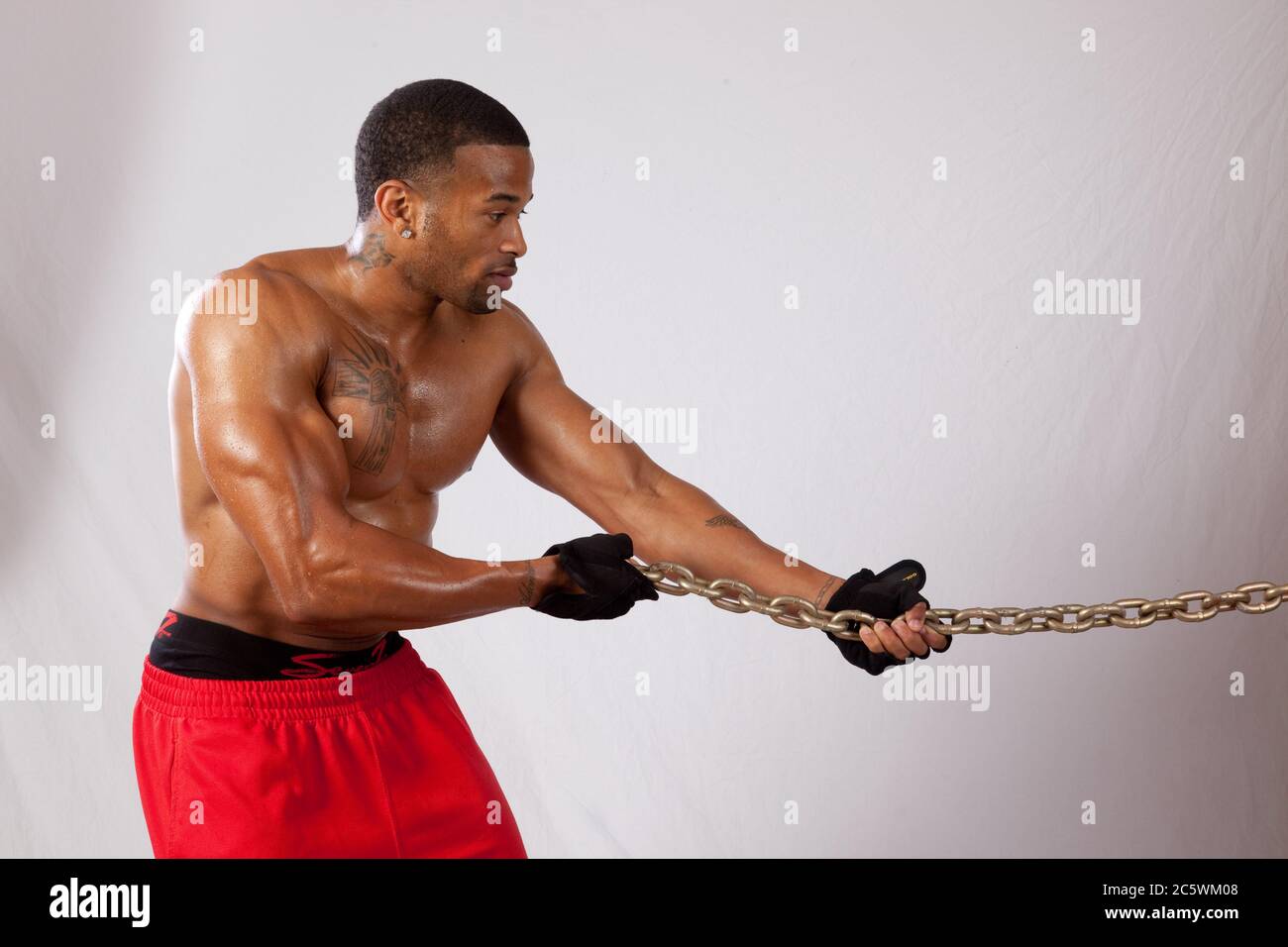 Strong black man with a chain around his wrist Stock Photo - Alamy