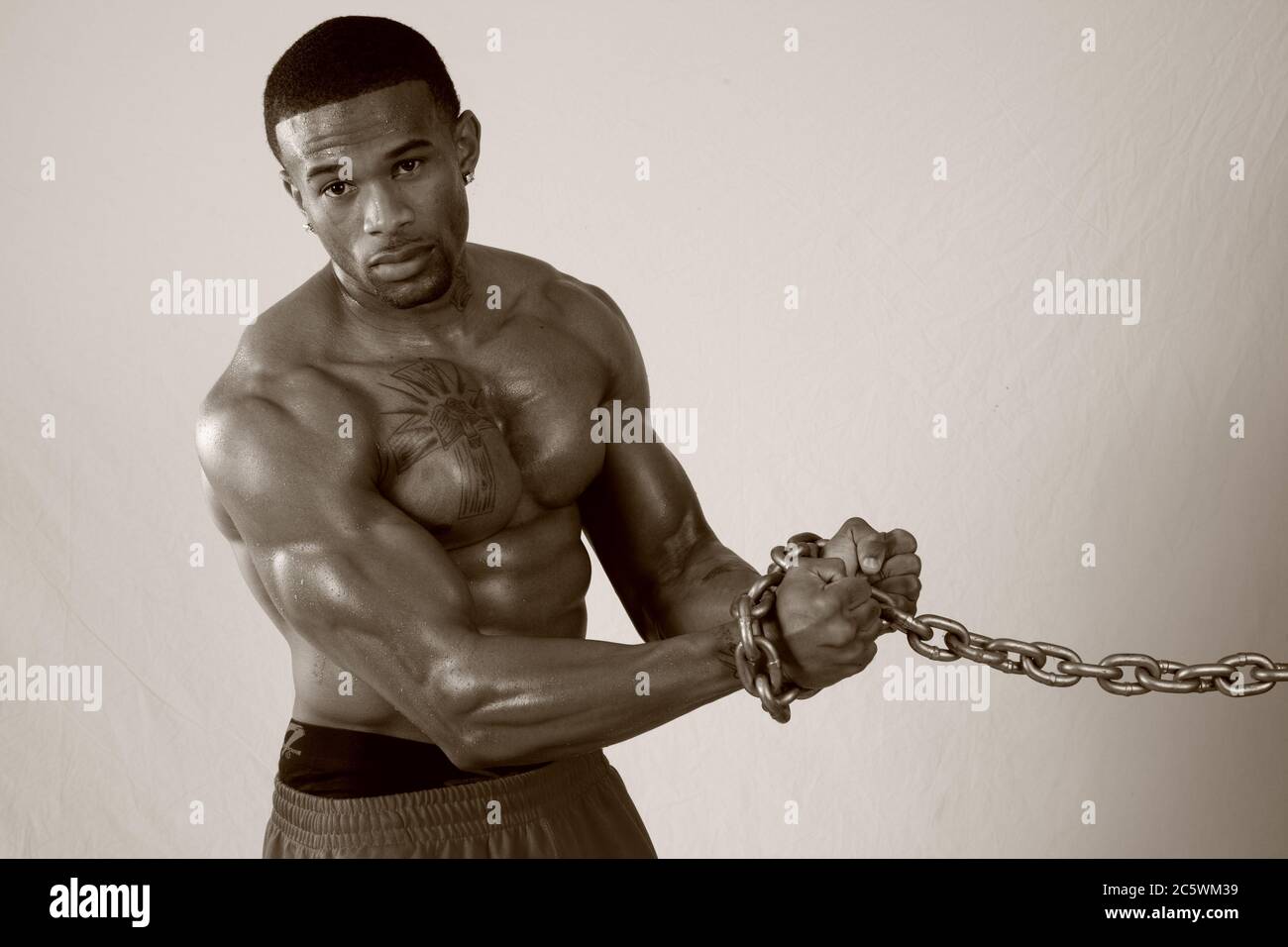 Strong black man with a chain around his wrist Stock Photo - Alamy