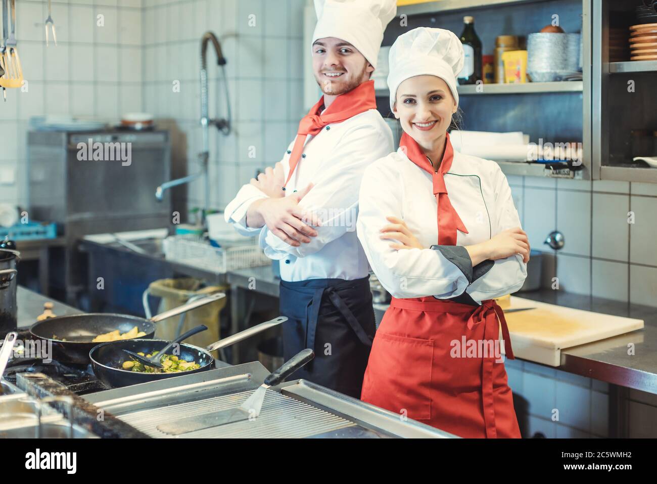 Super proud and cool chef cooks in the kitchen posing for the camera ...
