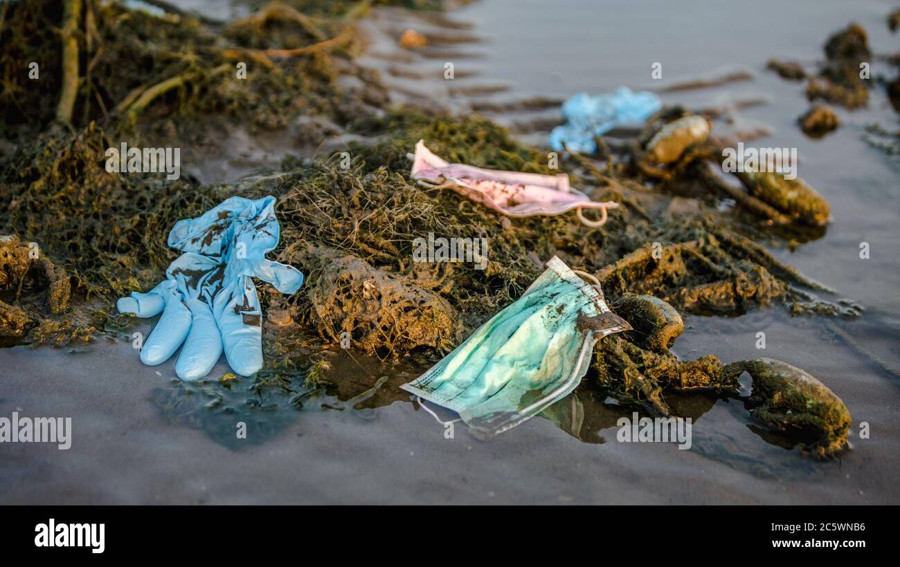 Coronavirus plastic waste polluting the environment. Disposable masks ...
