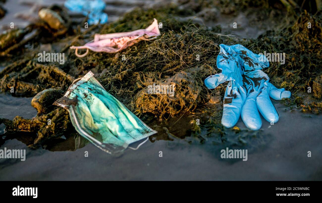 Coronavirus plastic waste polluting the environment. Disposable masks ...