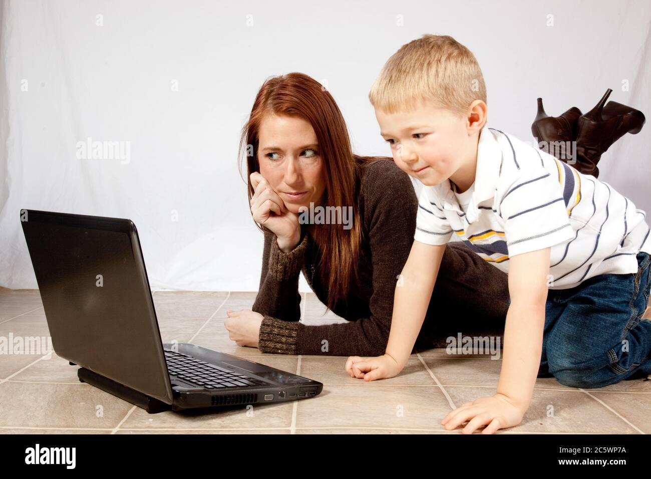 Mother and son with a computer together Stock Photo - Alamy