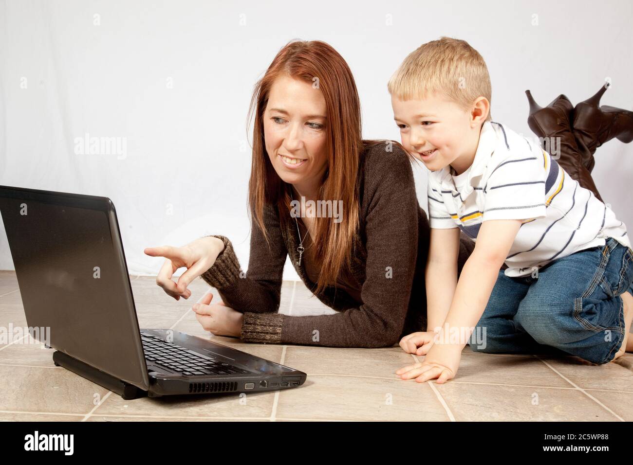 Mother and son with a computer together Stock Photo - Alamy