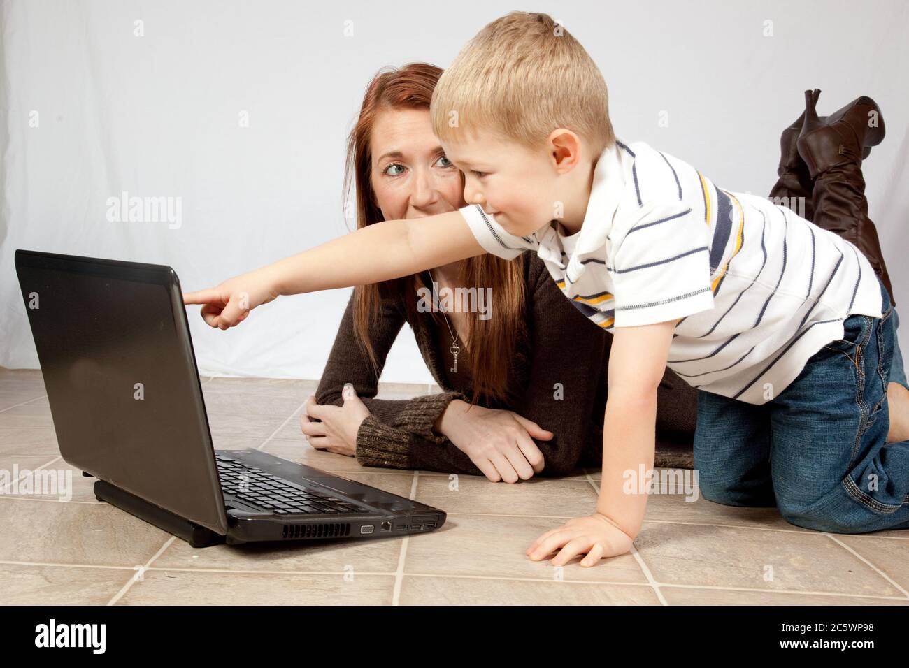 Mother and son with a computer together Stock Photo - Alamy