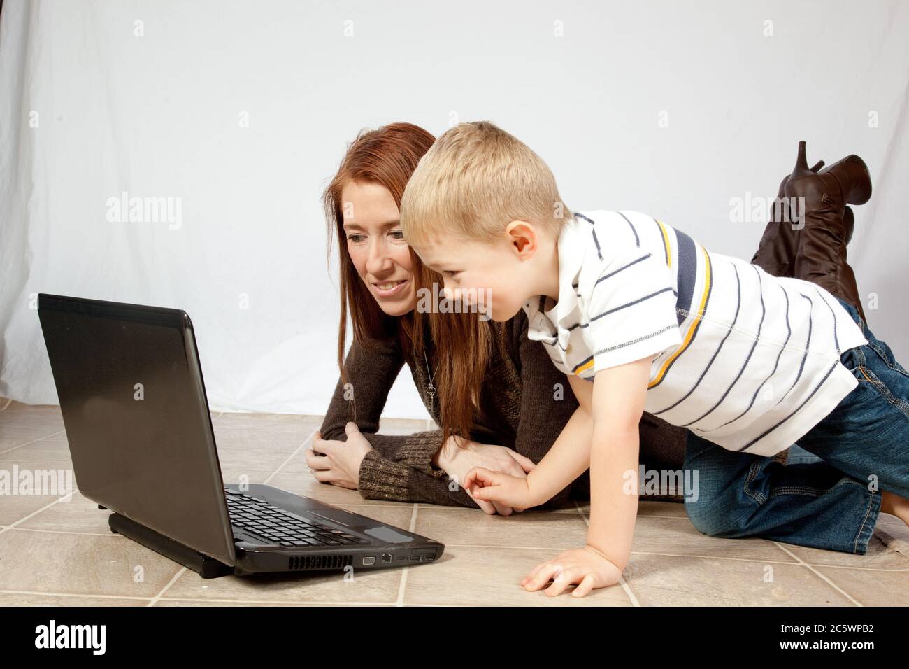 Mother and son with a computer together Stock Photo - Alamy