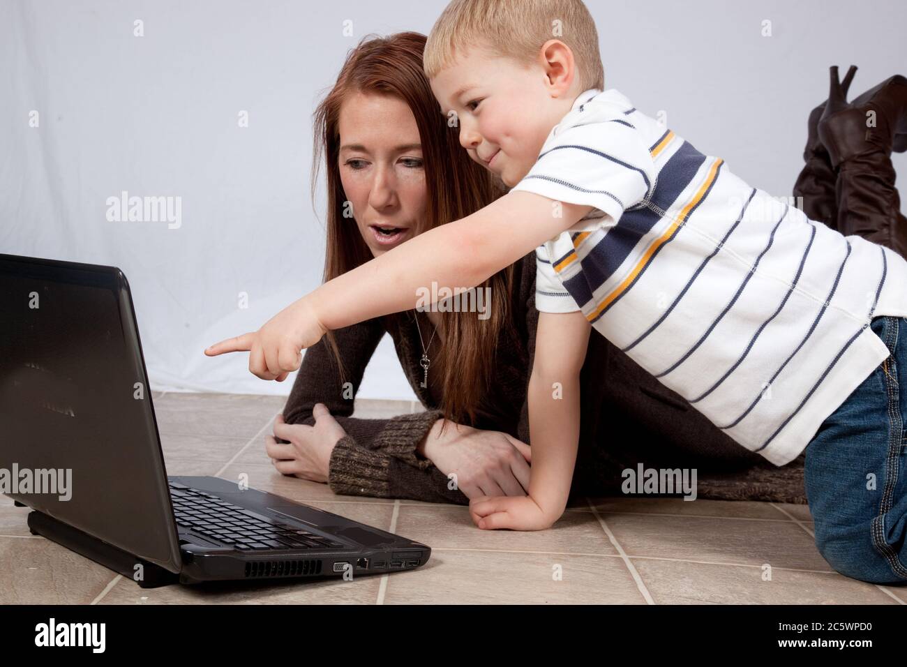 Mother and son with a computer together Stock Photo - Alamy