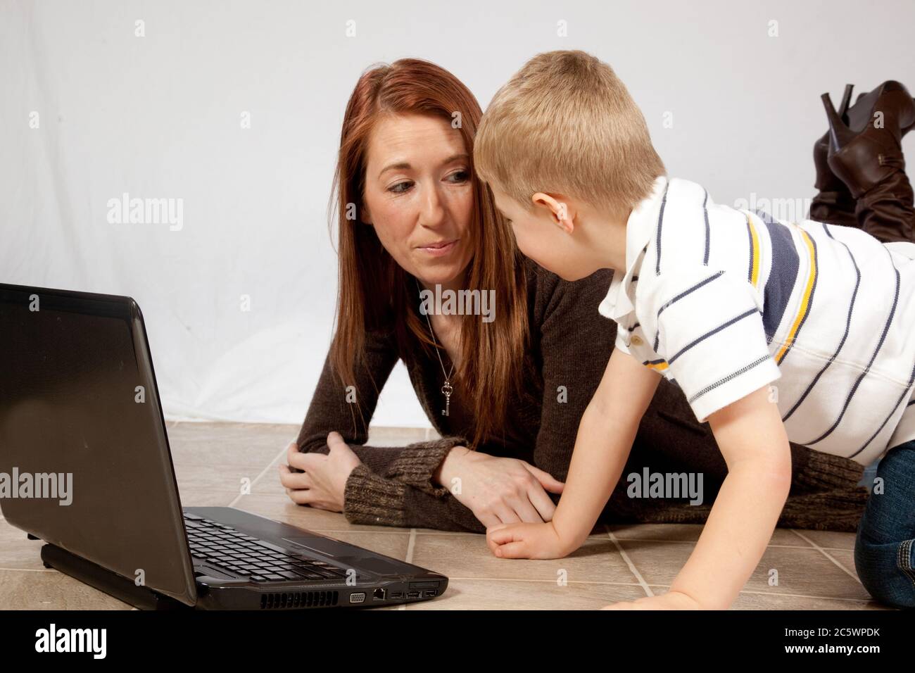 Mother and son with a computer together Stock Photo - Alamy