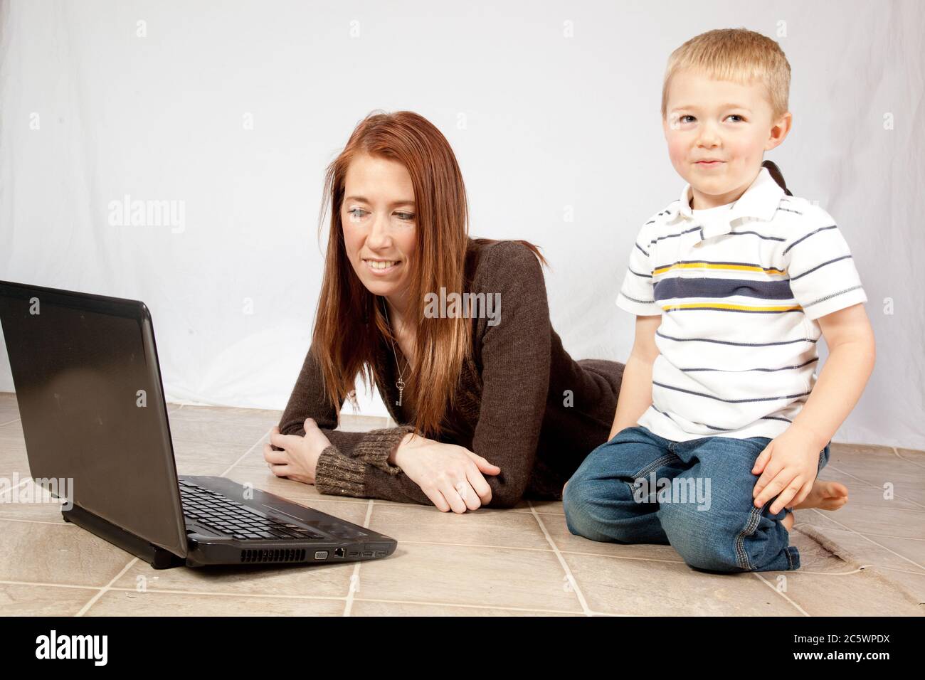 Mother and son with a computer together Stock Photo - Alamy