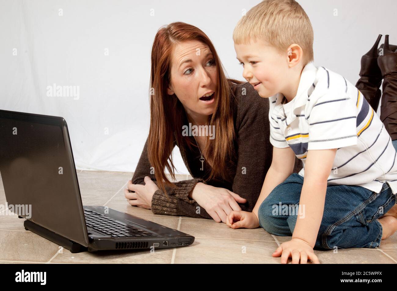 Mother and son with a computer together Stock Photo - Alamy