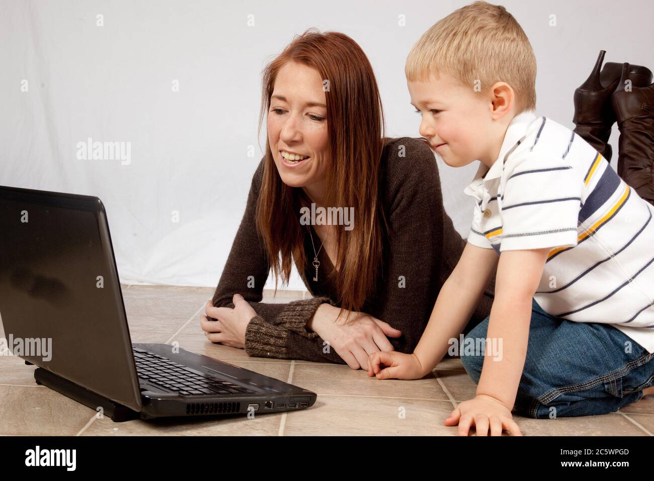 Mother and son with a computer together Stock Photo - Alamy