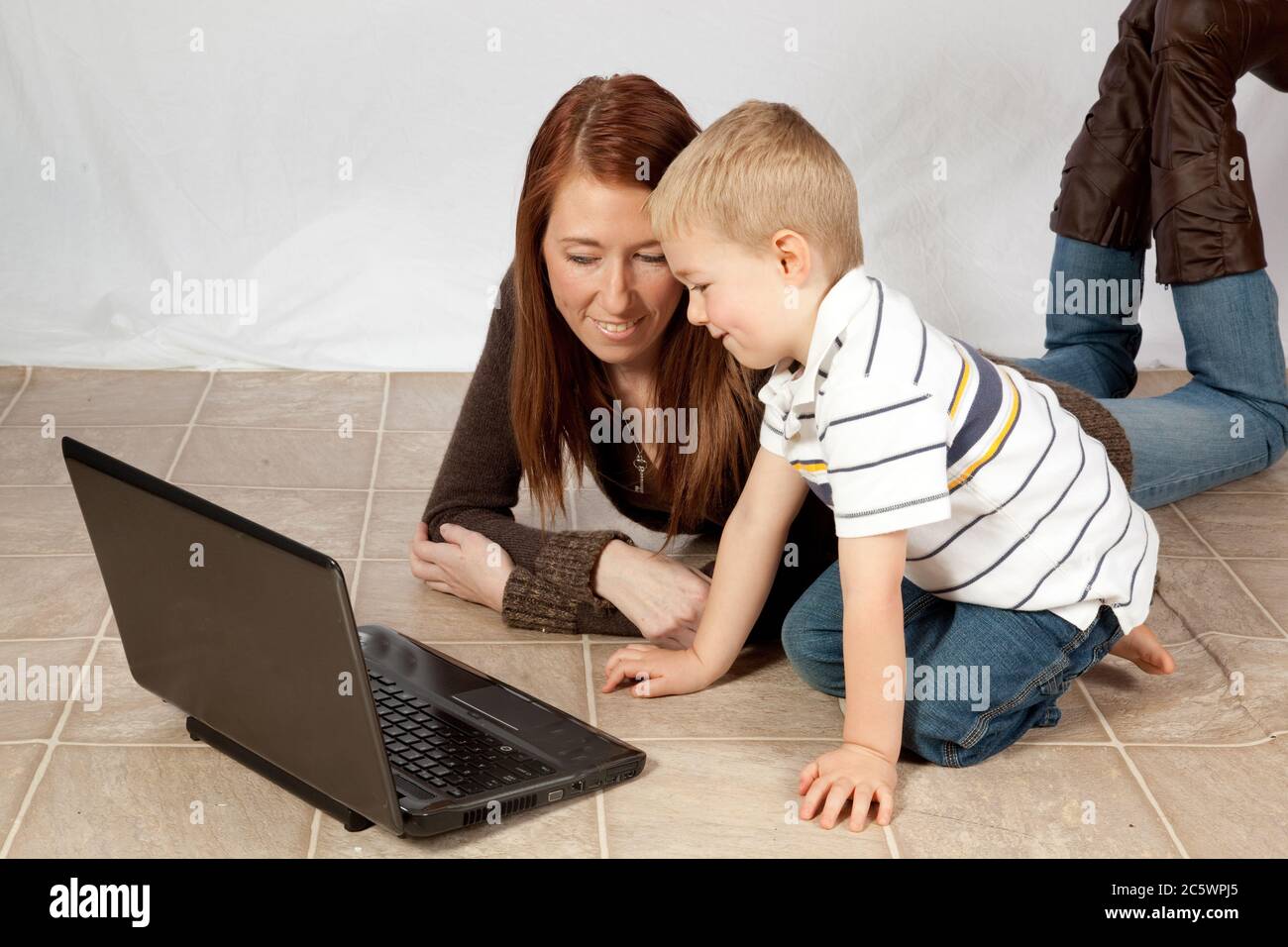 Mother and son with a computer together Stock Photo - Alamy