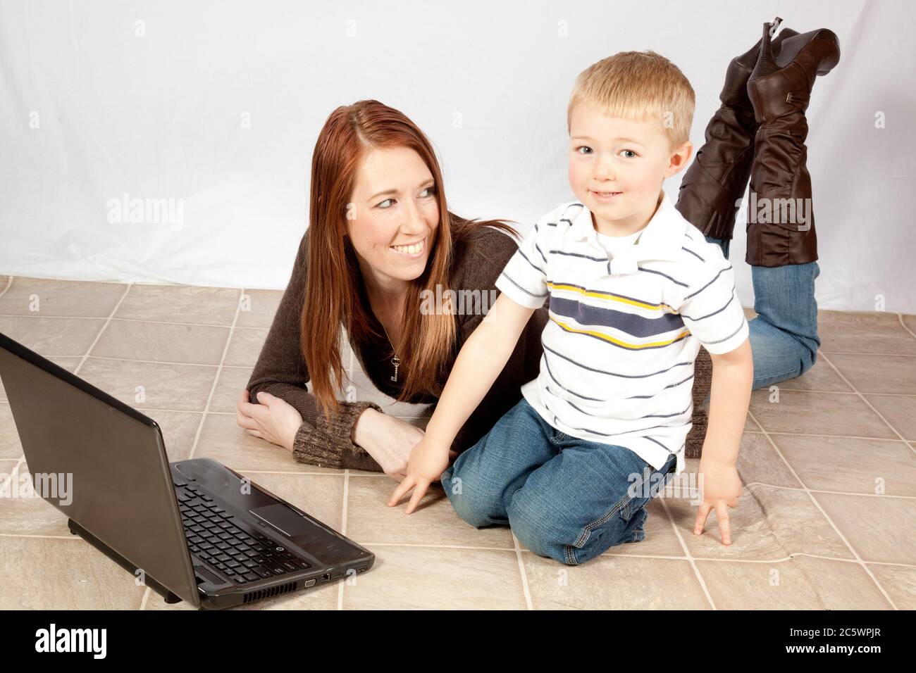 Mother and son with a computer together Stock Photo - Alamy