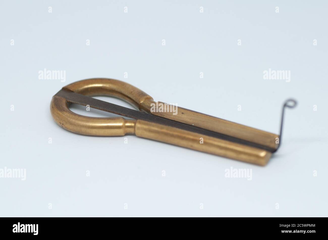 Macrophotography of an old jaw harp - isolated on white background ...