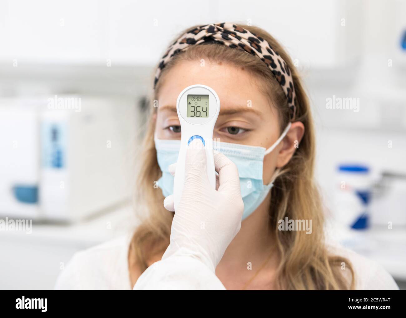 A Patient at a hospital has her temperature taken, measures have been ...