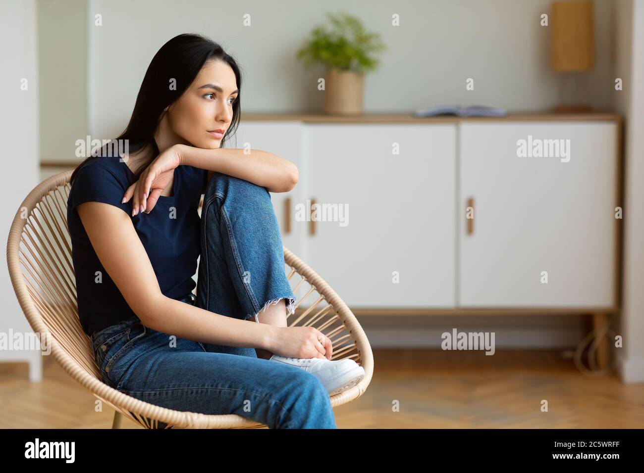 Relaxed Young Woman Thinking Sitting In Modern Armchair Relaxing Indoor ...
