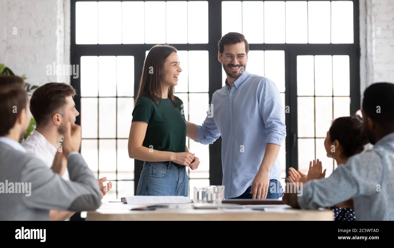 Promoted female employee receive congrats from company staff Stock ...