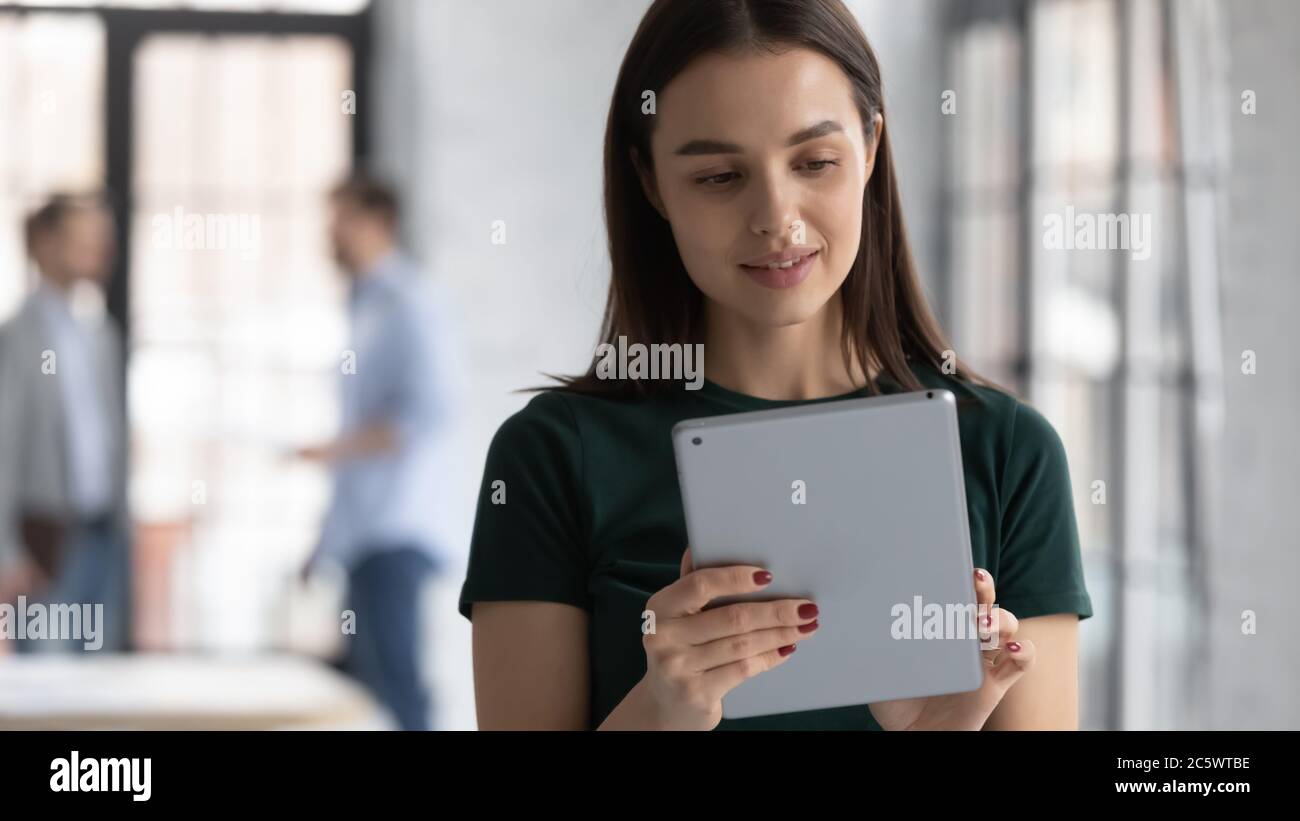 Employee holding tablet preparing presentation on electronic device in ...