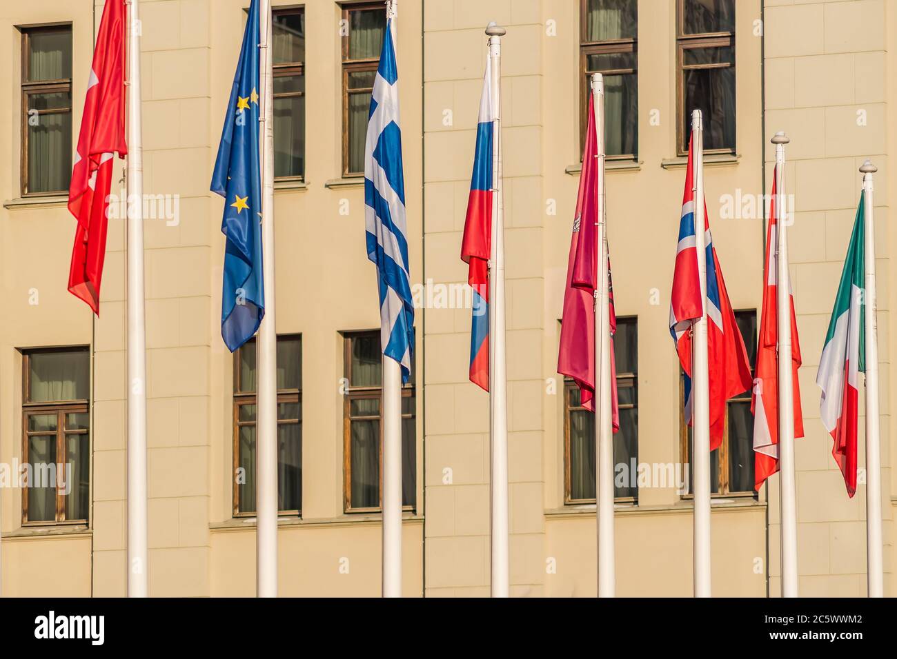 Colorful flags from different countries on building background Stock ...