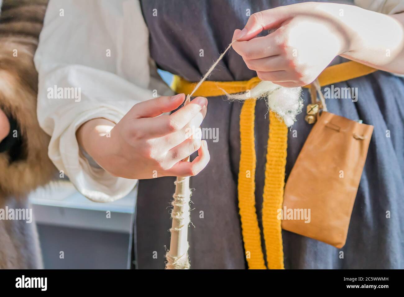 woman in traditional russian clothes weaves a spindle Stock Photo - Alamy