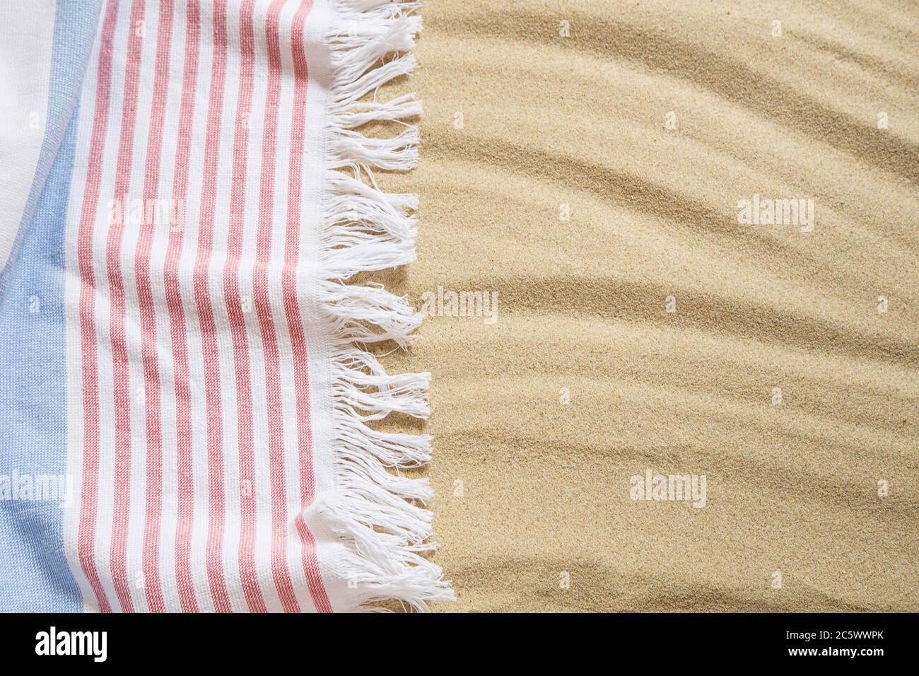 Beach towel on sand background Stock Photo - Alamy