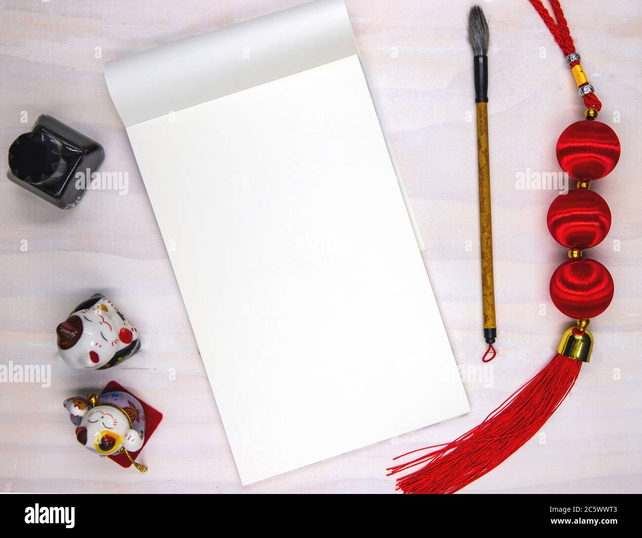 Blank notebook page and calligraphy supply. Chinese red knot and maneki ...