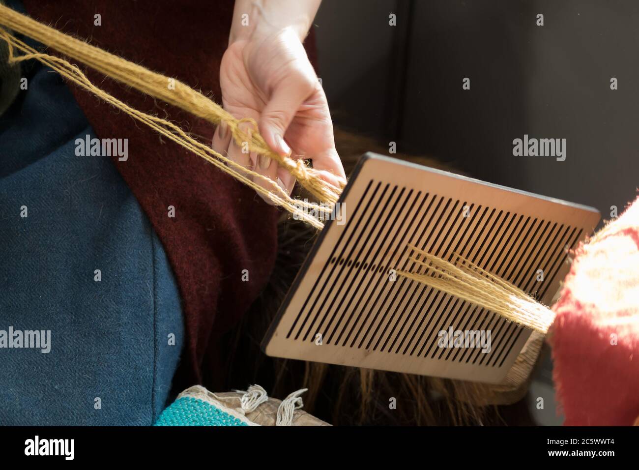 woman in traditional russian clothes weaves a spindle Stock Photo - Alamy