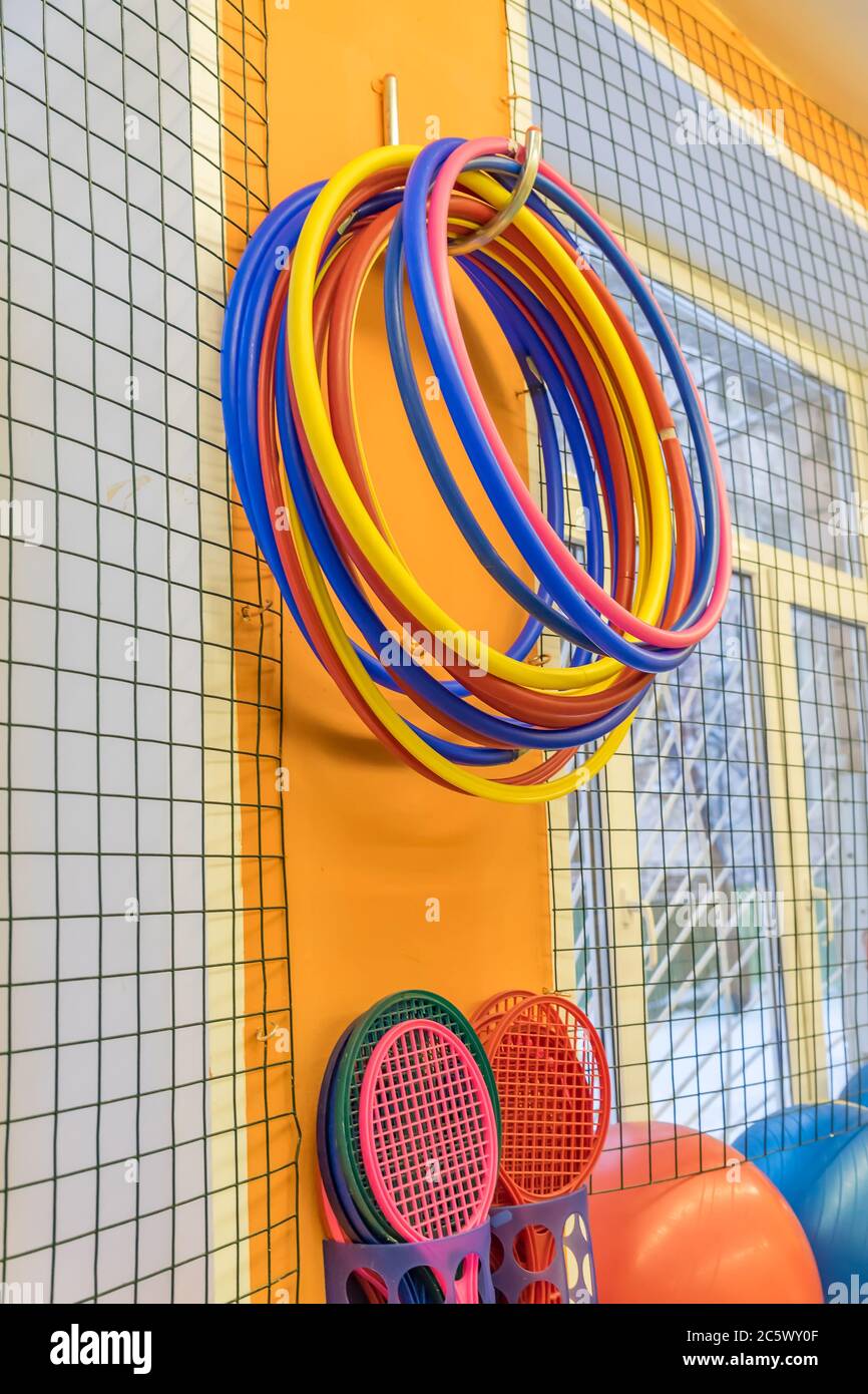 sport equipment - hoop, tennis racket, fitball in gym Stock Photo - Alamy