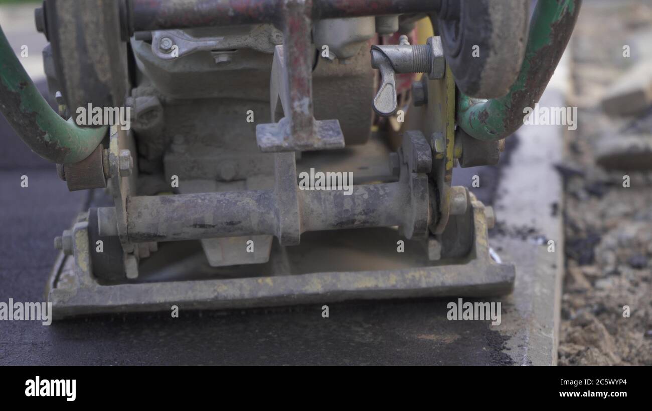 Vibratory asphalt paving machine on the sidewalk filmed close-up.Road ...