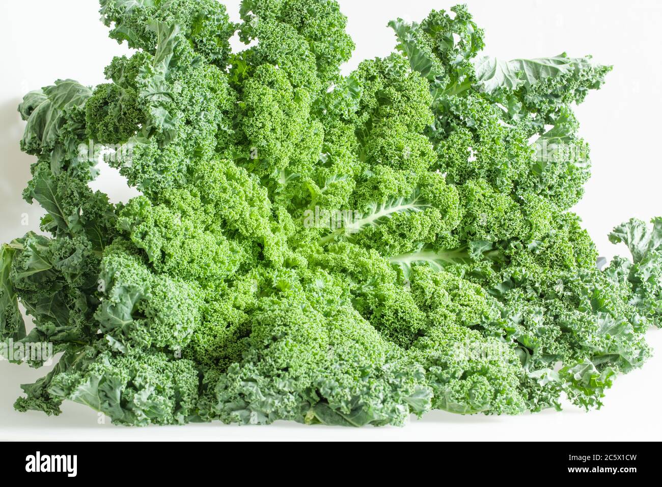 Fresh green organic curly kale leaves isolated on white Stock Photo - Alamy