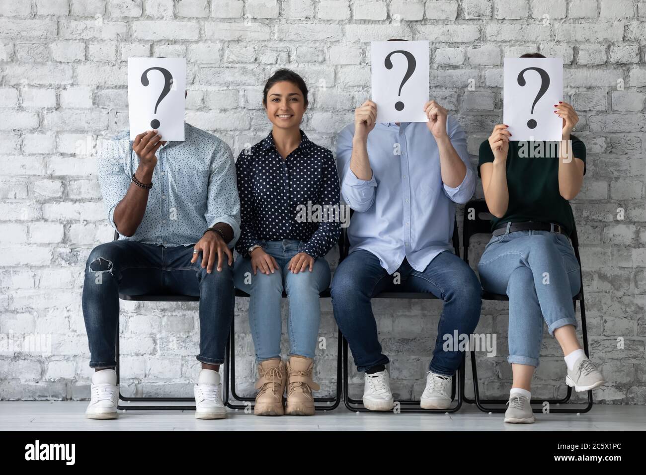 Applicant sit with competitors people hiding faces behind question ...