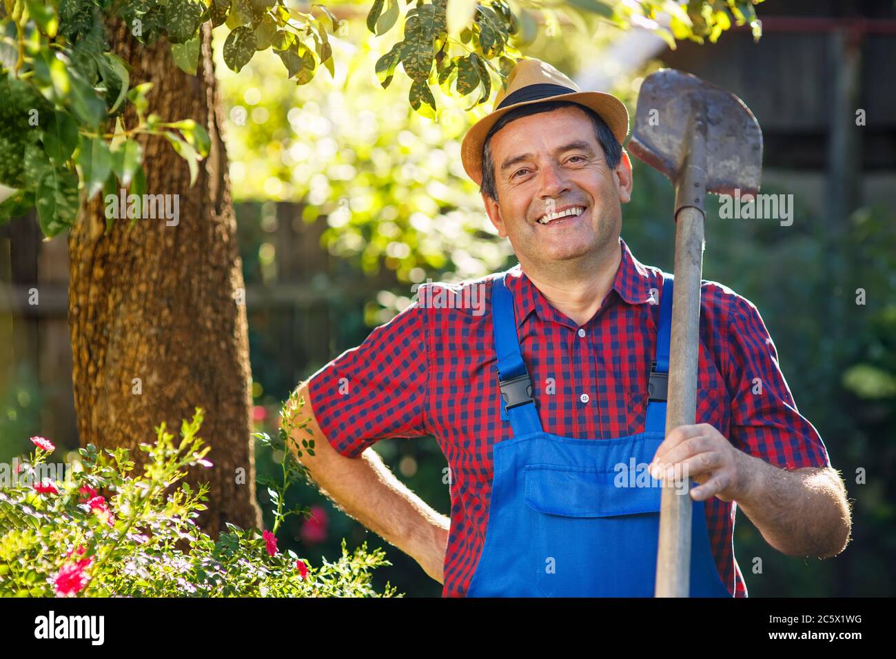 Portrait happy farmer spade hi-res stock photography and images - Alamy