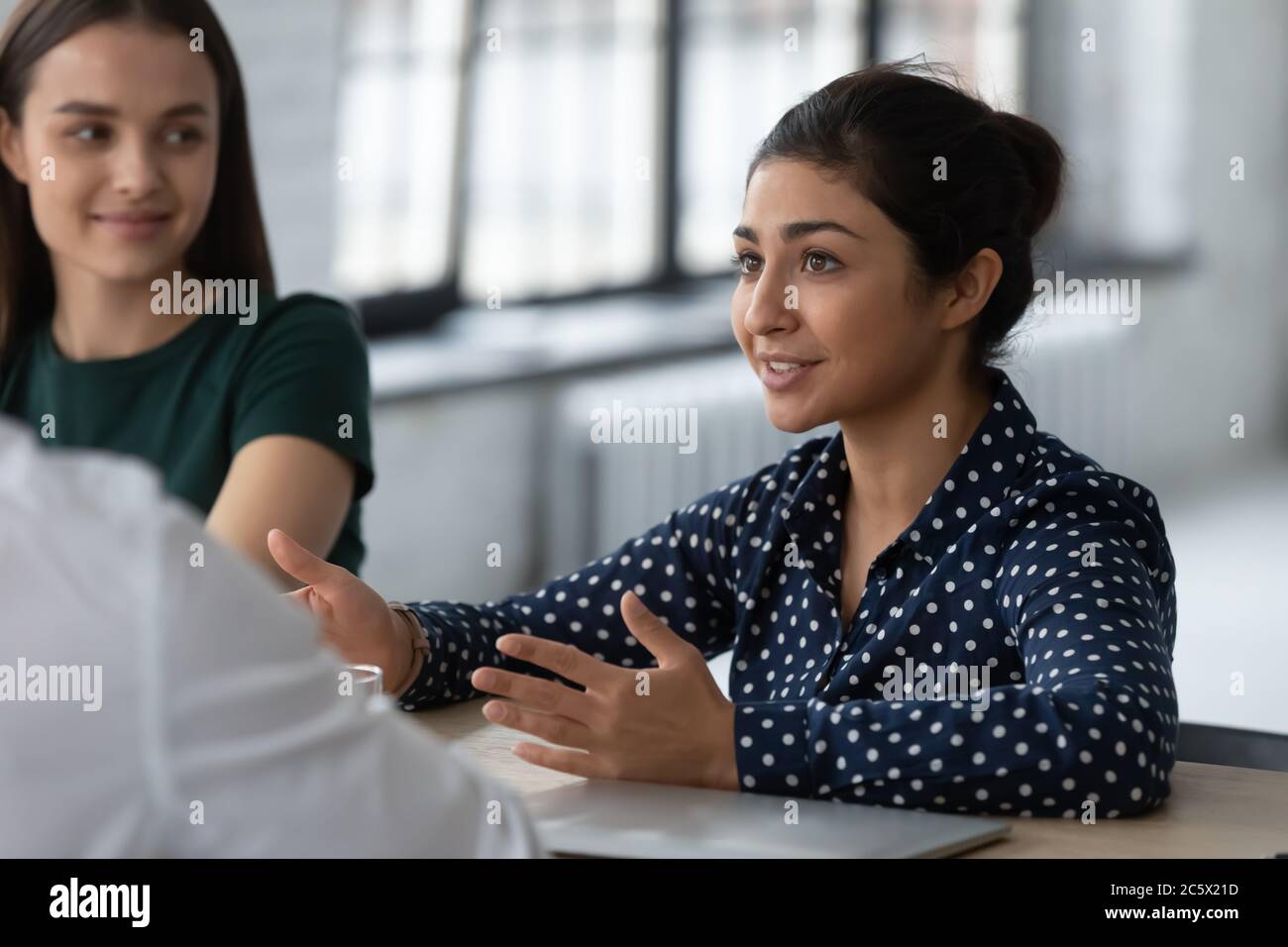 Indian applicant is interviewed by HR managers during job interview ...