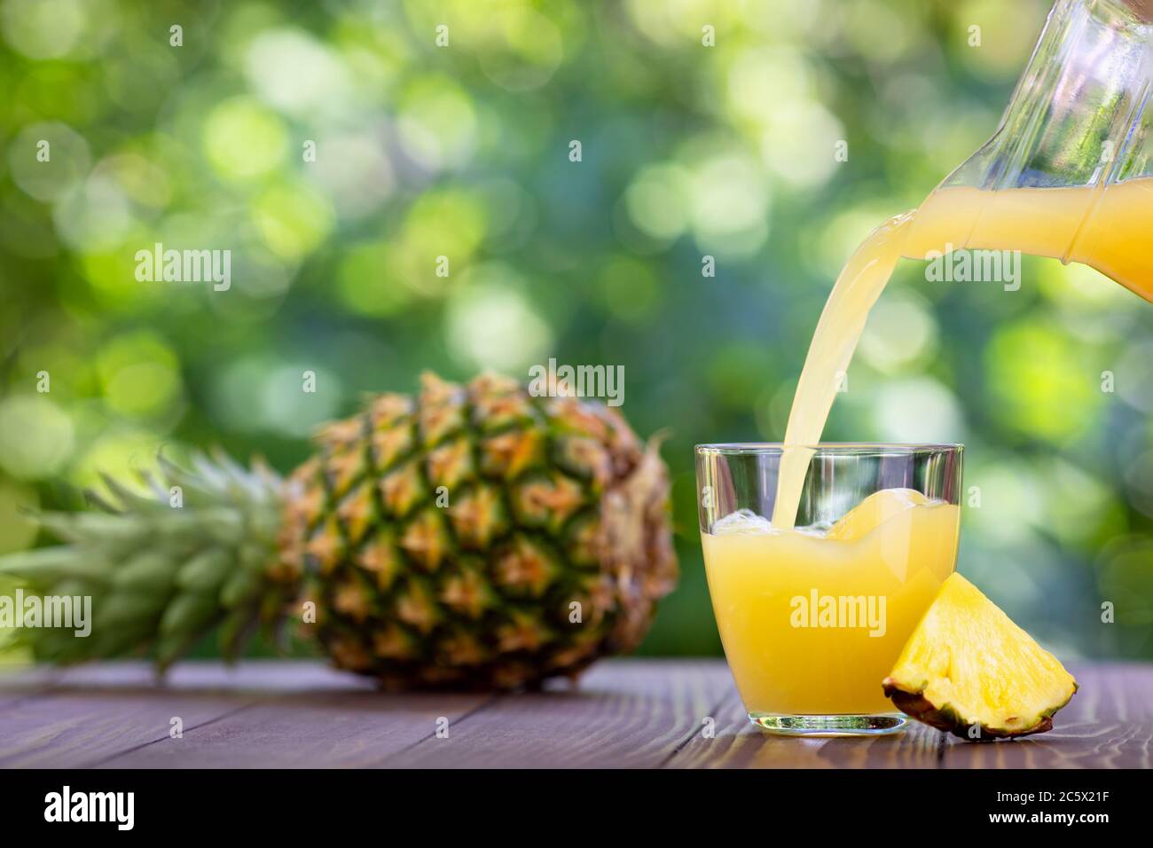 pineapple juice pouring into glass Stock Photo - Alamy