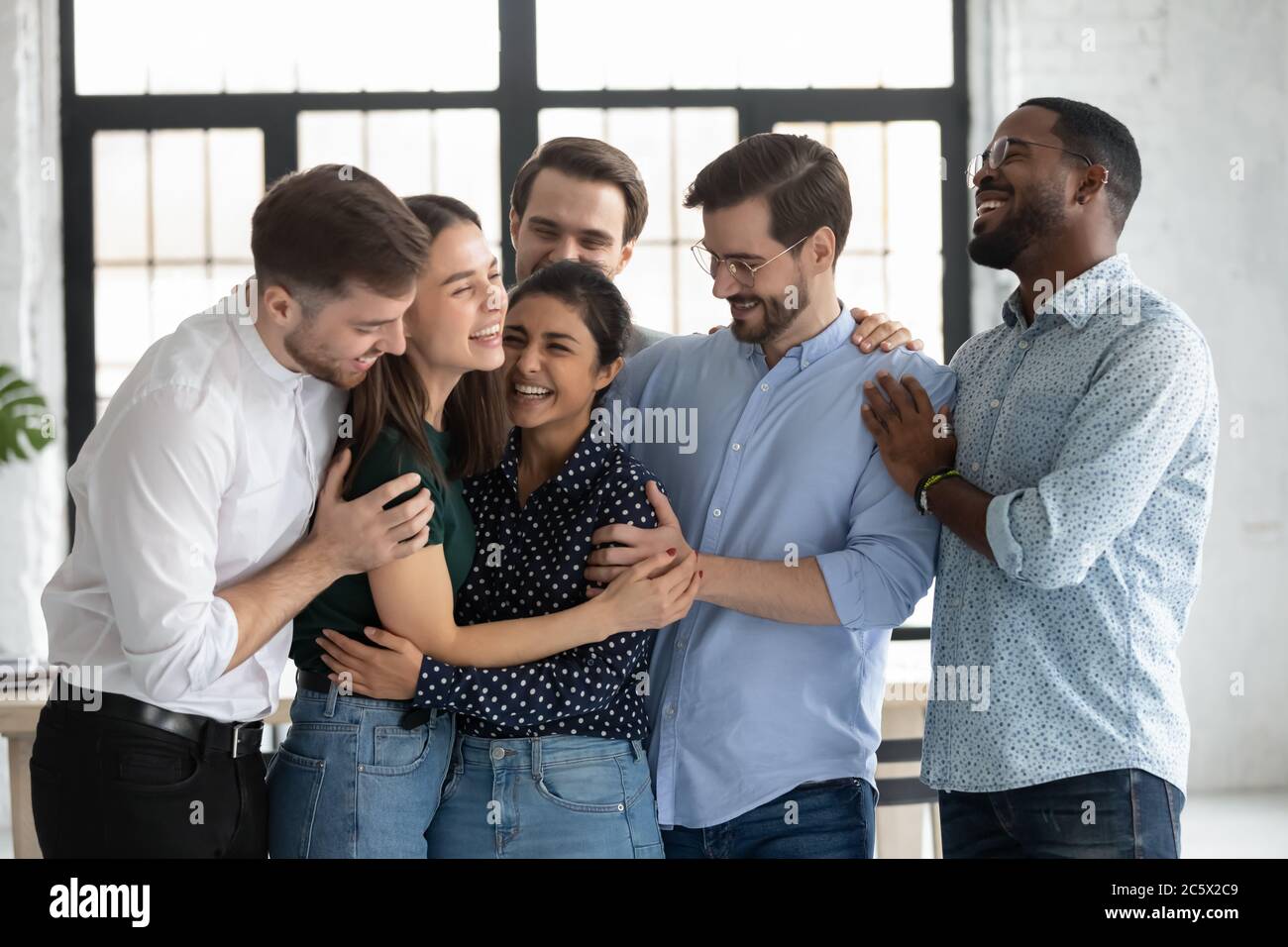 Hugging each other celebration hi-res stock photography and images - Alamy