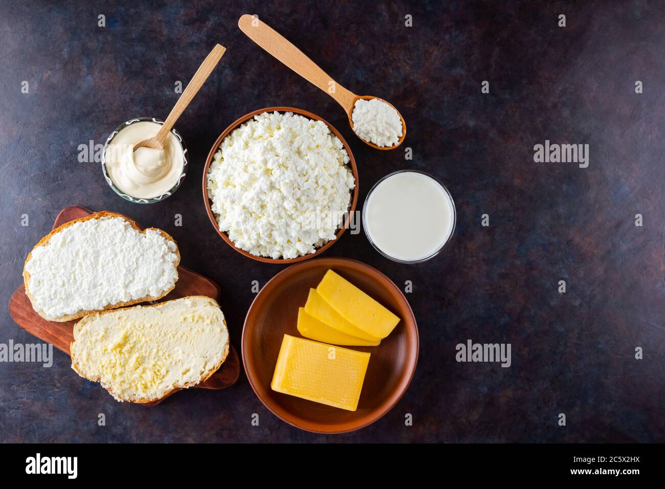 Dairy products. Milk, cottage cheese, hard cheese and sour cream on a ...