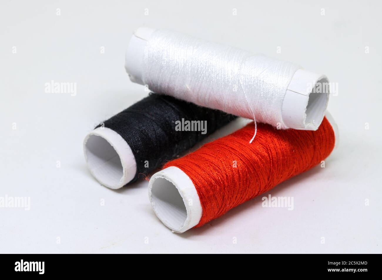 Thread spool pile on white background. Basic color of thread: red ...