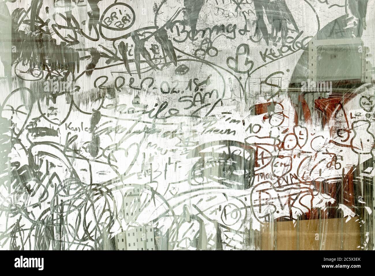 Drawings and writings on window whitewash paint creates an abstract ...