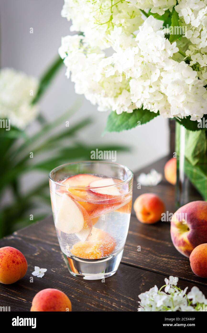 Refreshing drink with apricots and peaches, cold sparkling water with ...