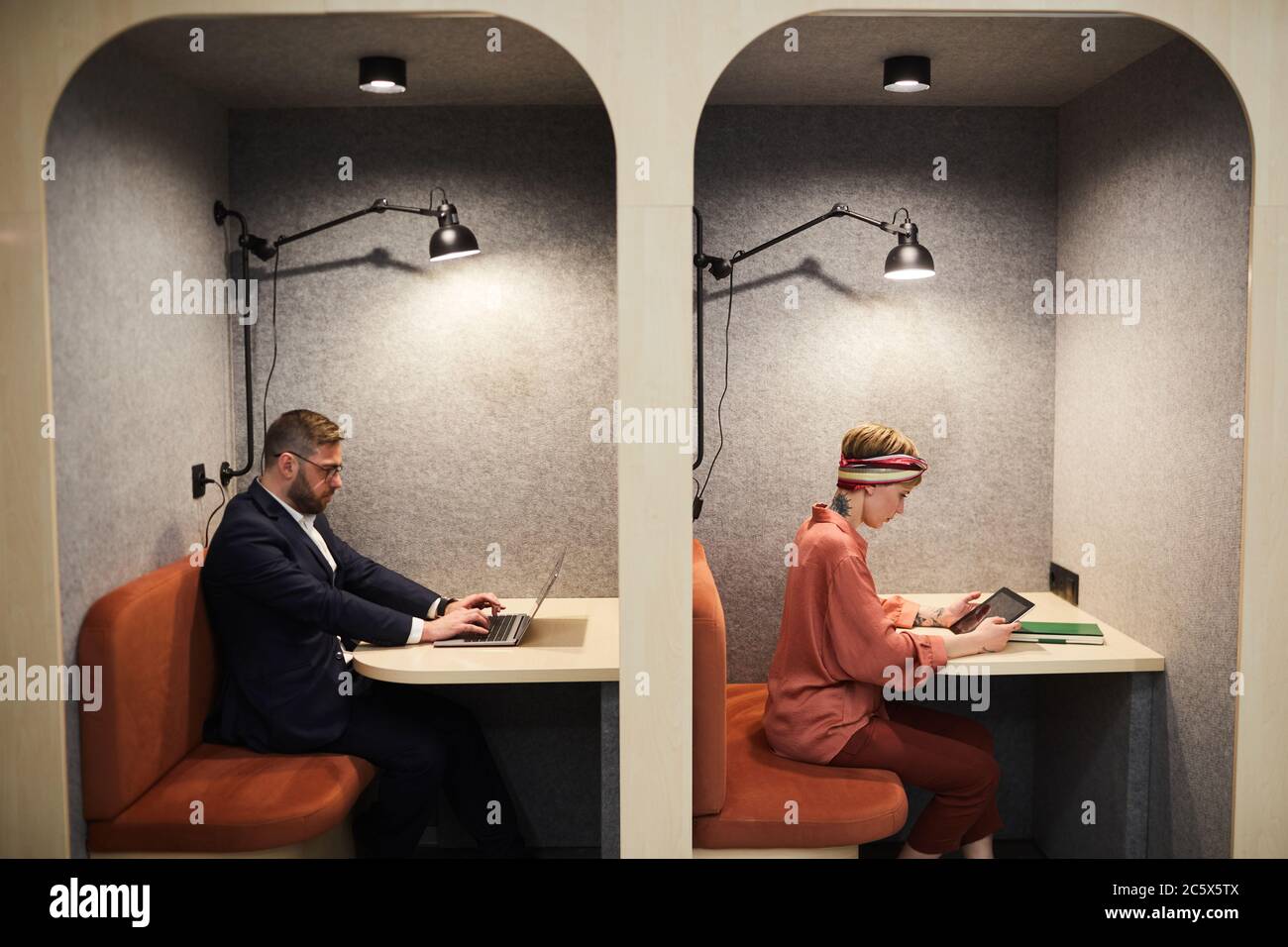 Graphic side view portrait of two business people working in separate ...