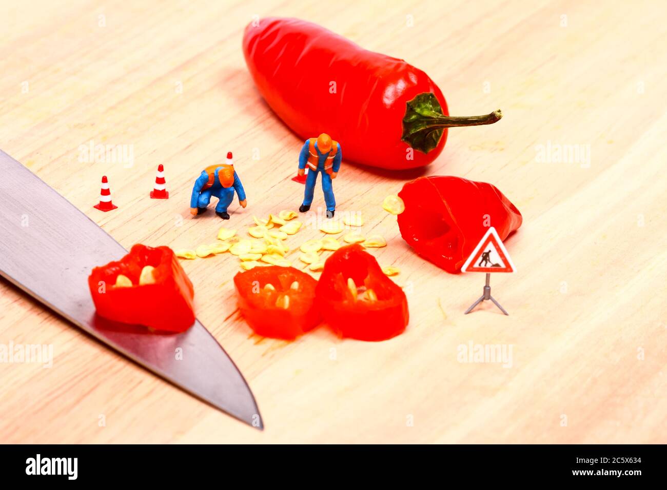 Cookery diorama with miniature figure workmen on a wooden chopping ...