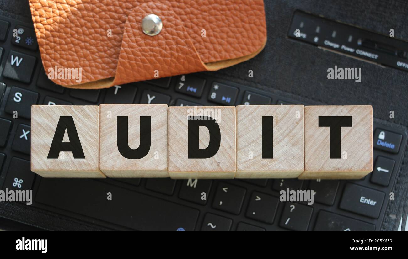 Audit word on wooden cubes on computer keyboard. Financial concept ...