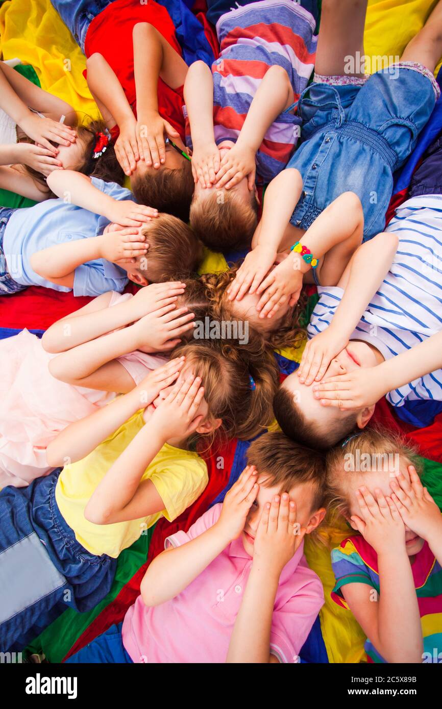 Kids taking a break relaxing on the floor Stock Photo - Alamy