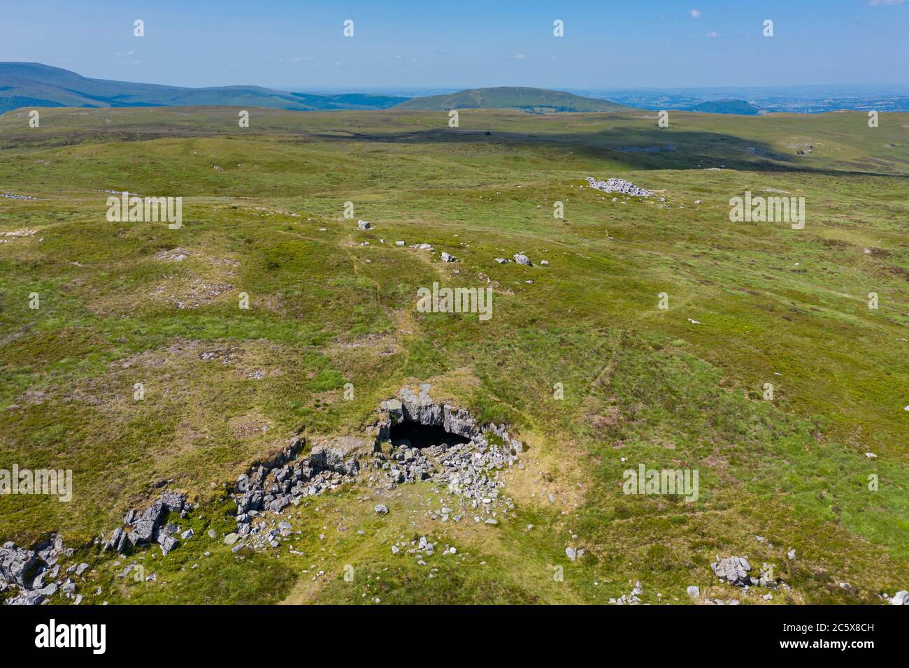 Aerial view of the entrance to an underground cave system on remote ...