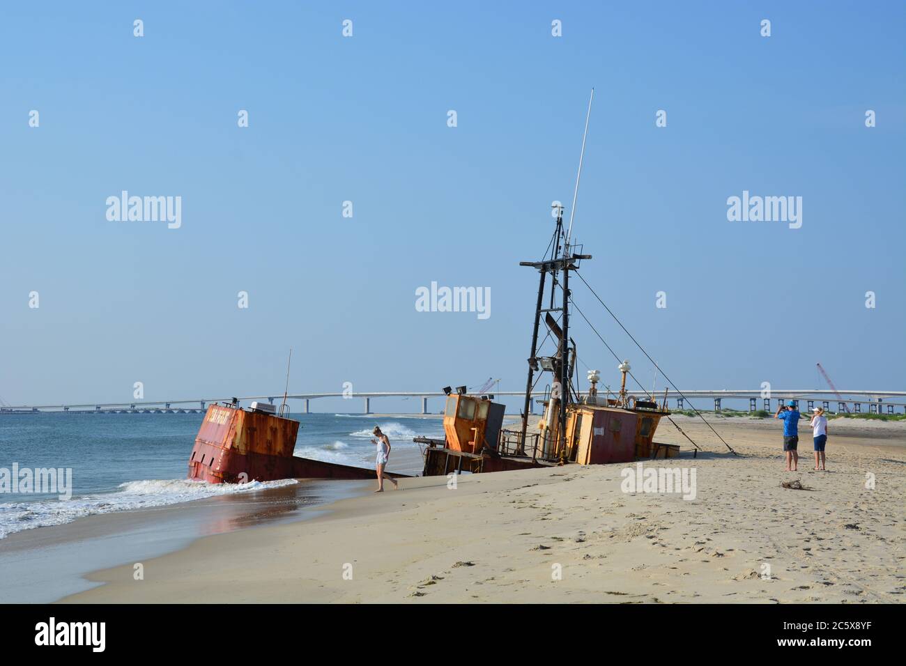 People inspect the fishing trawler Ocean Pursuit stranded on the beach ...